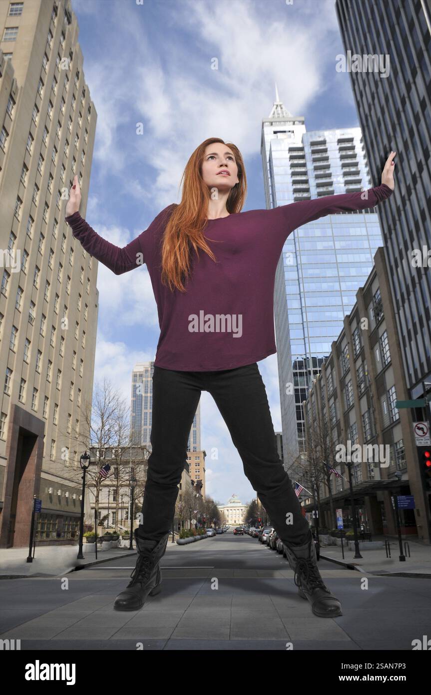 Beautiful giant woman holding up some buildings Stock Photo - Alamy