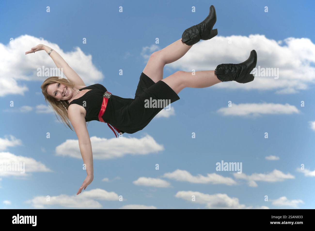 Beautiful young woman falling through the sky Stock Photo - Alamy