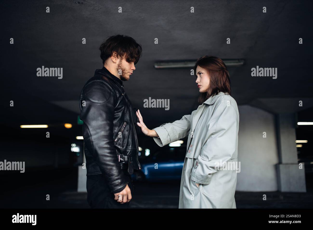 The couple stands facing each other closely, creating a focused and ...