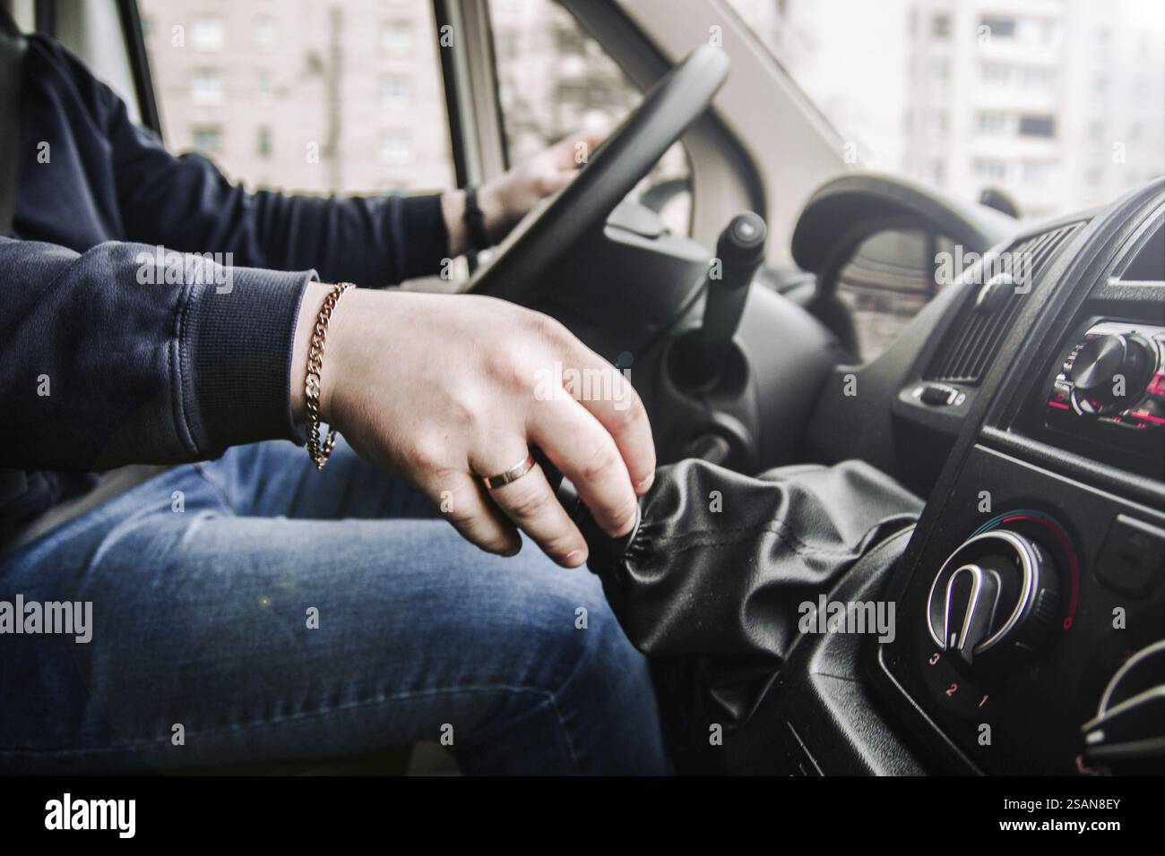 Close-up of a person's hand on a manual gear shift in a car Stock Photo ...