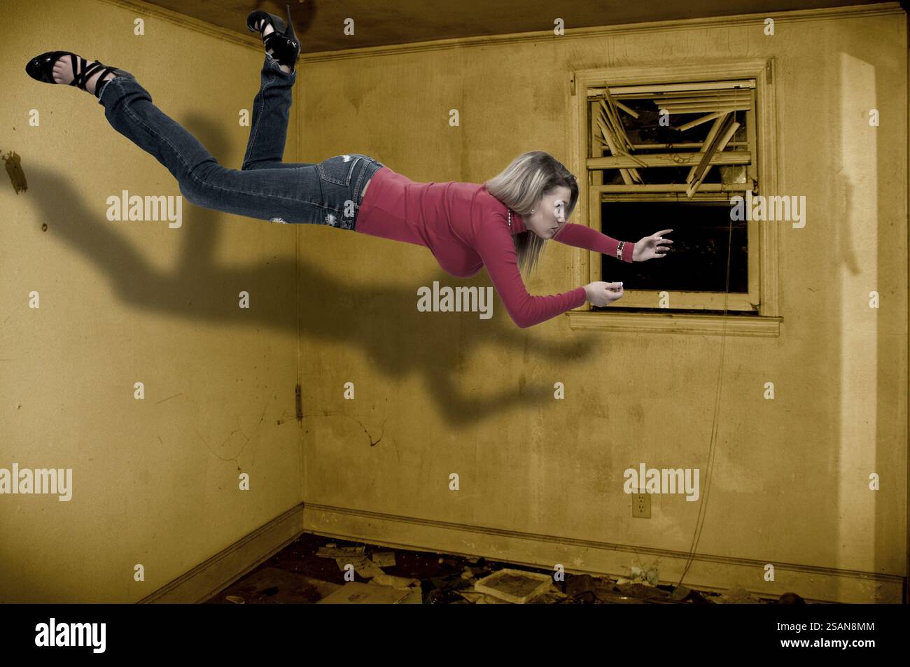 Beautiful young woman floating in the air Stock Photo - Alamy