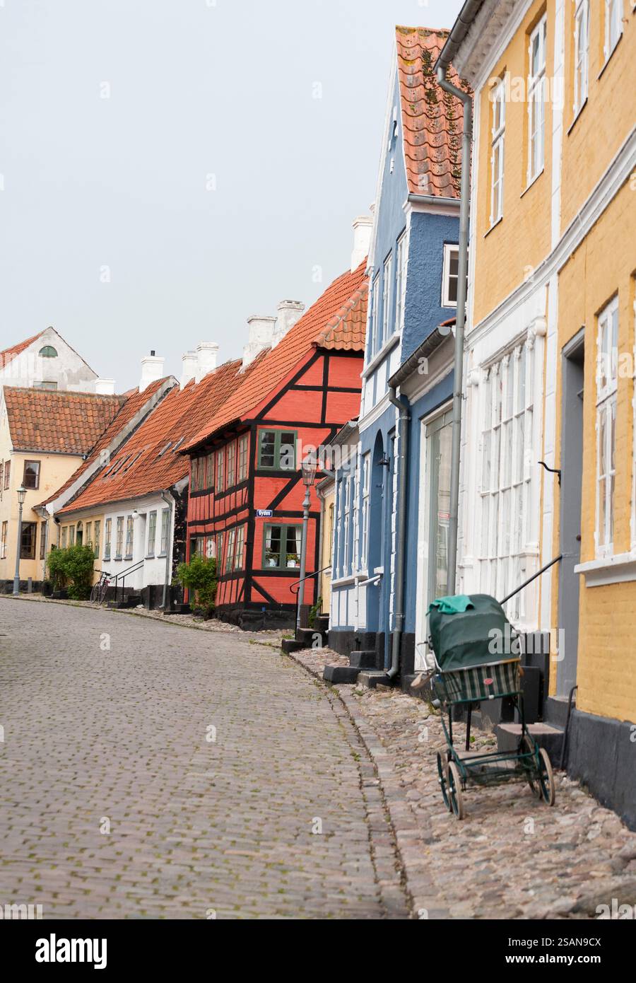 Curved Aero Streetscape with Baby Carriage: A curved cobblestone street ...