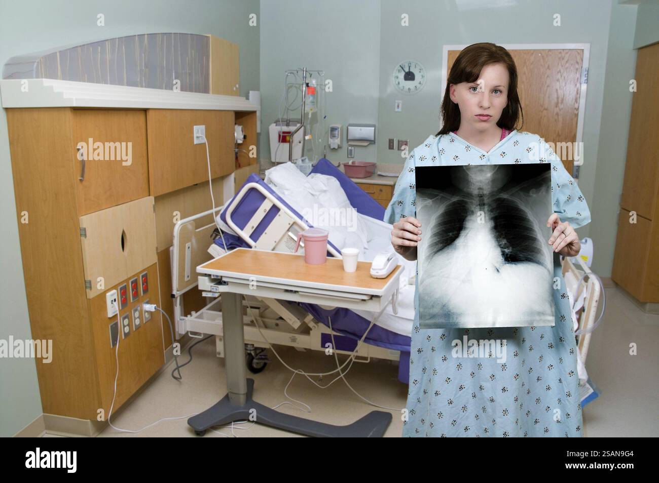 A beautiful female patient holding a chest x-ray Stock Photo - Alamy