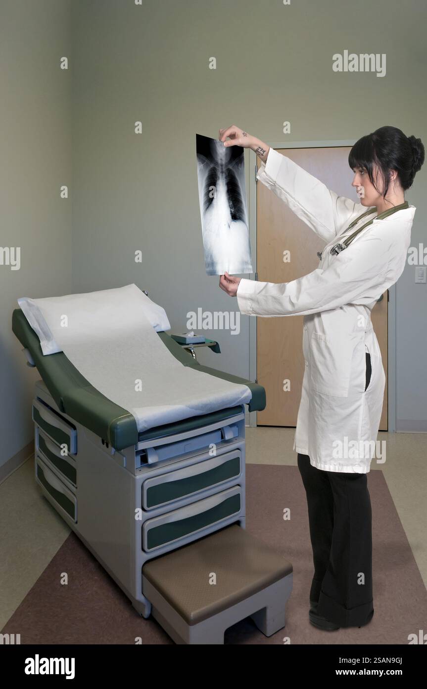 A beautiful female radiologist examining an x-ray Stock Photo - Alamy