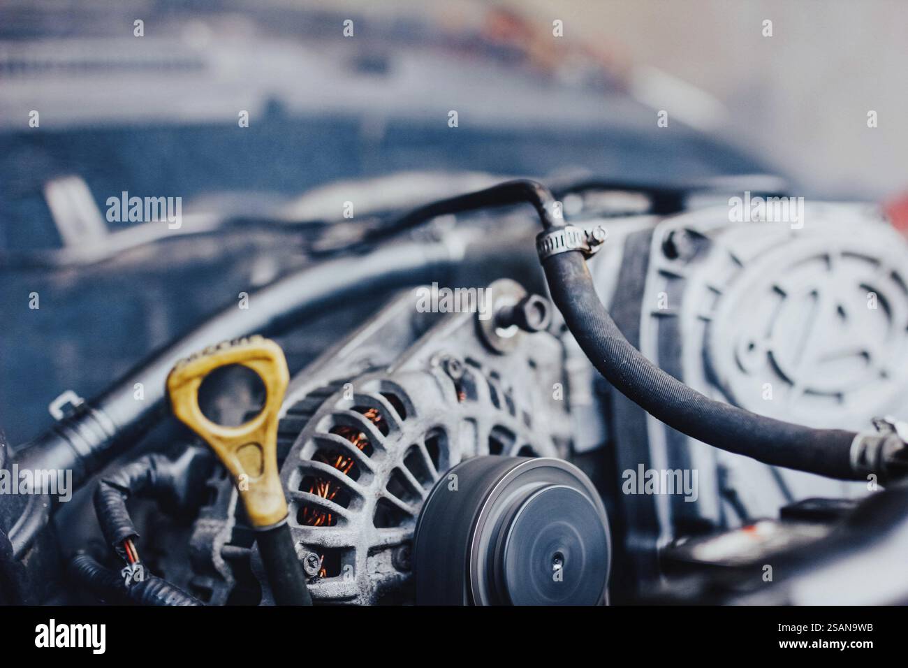 Close-up of a car engine, highlighting the alternator, belt, and ...