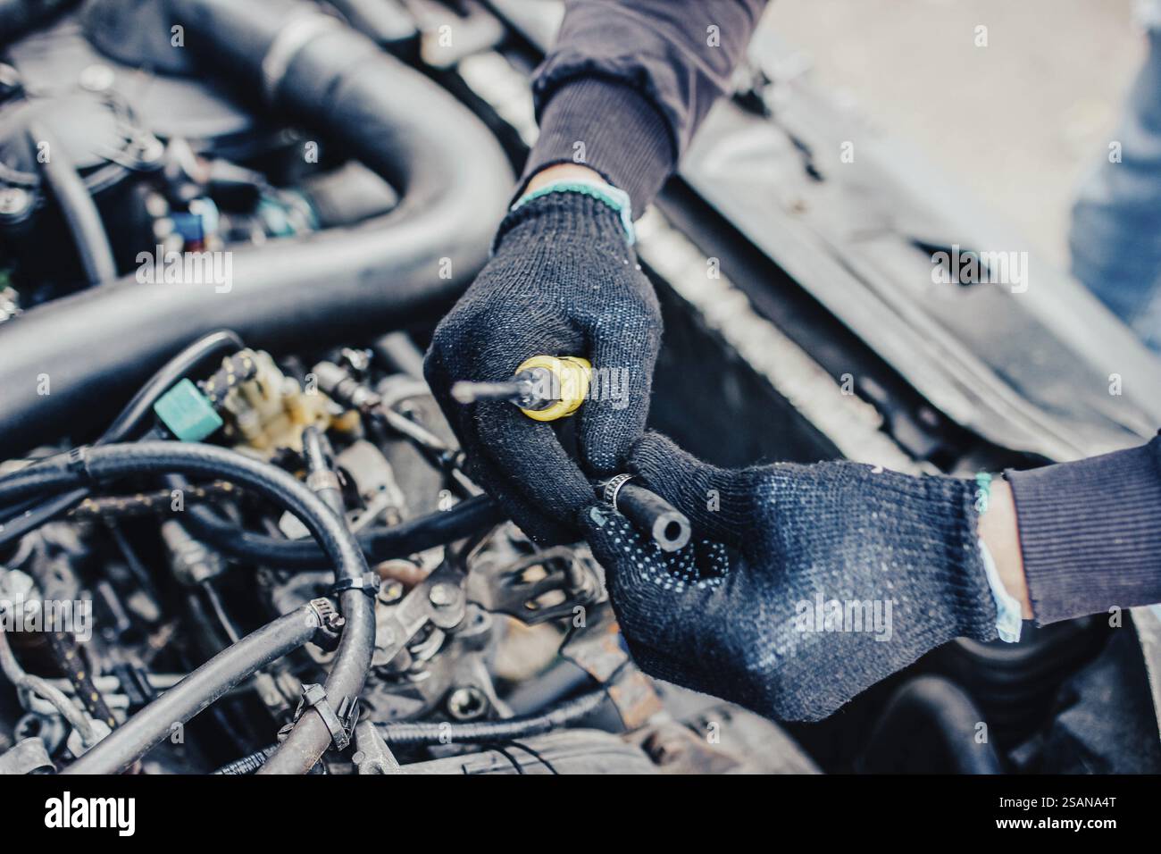 Hands repairing an engine with a tool, wearing protective gloves Stock ...