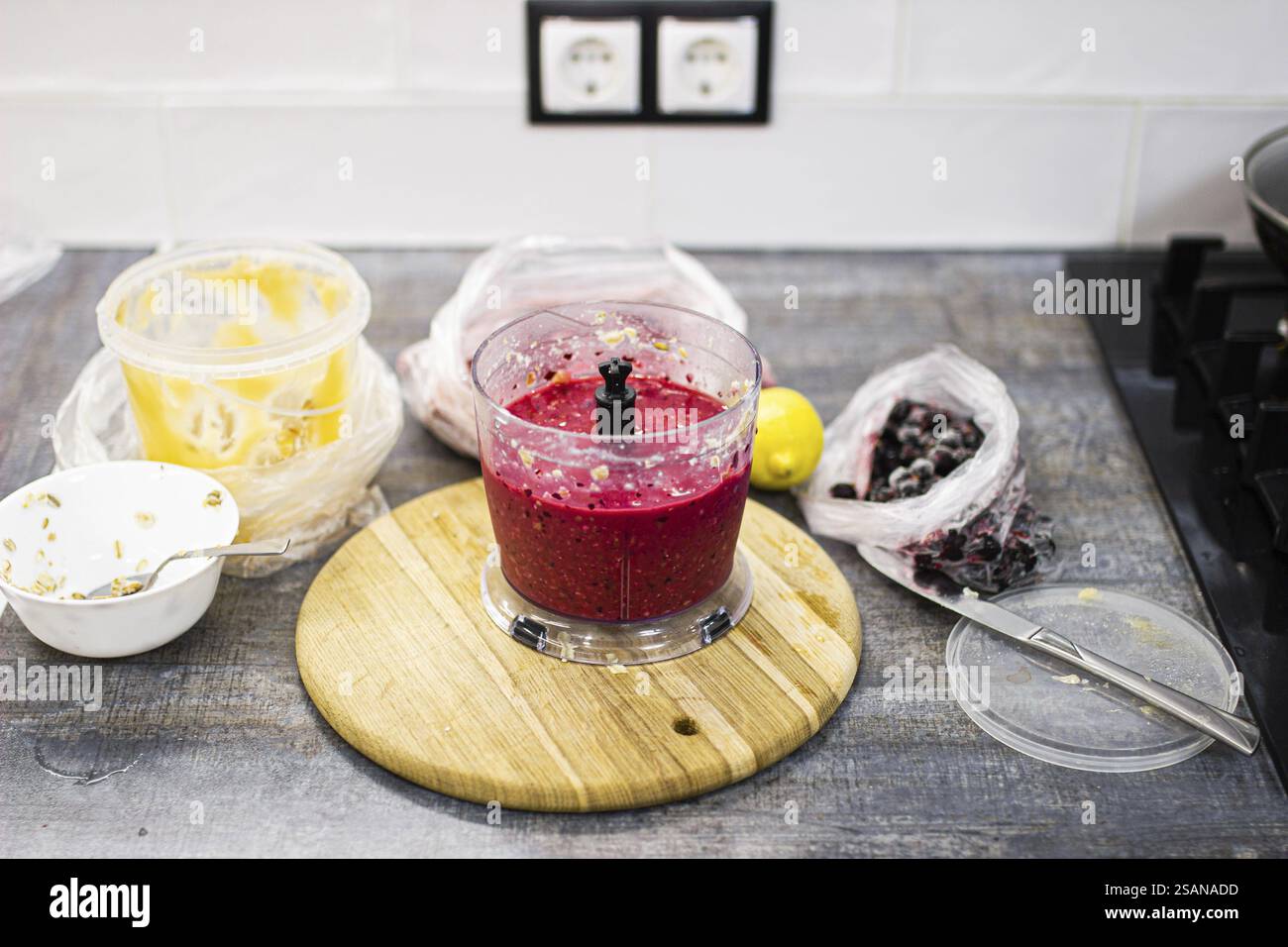 Kitchen scene showing smoothie ingredients and blender filled with ...