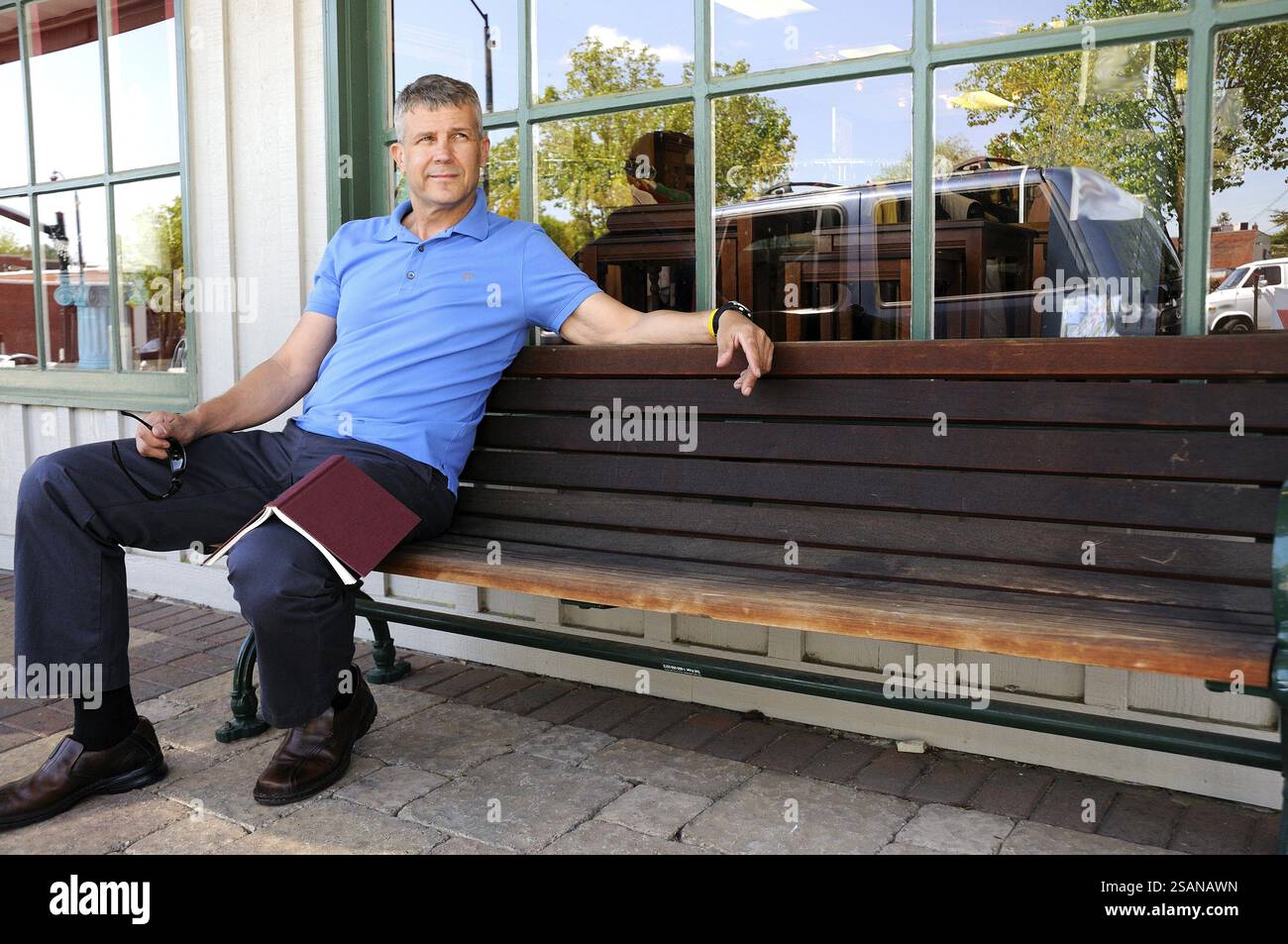 Male individual seated on bench hi-res stock photography and images - Alamy