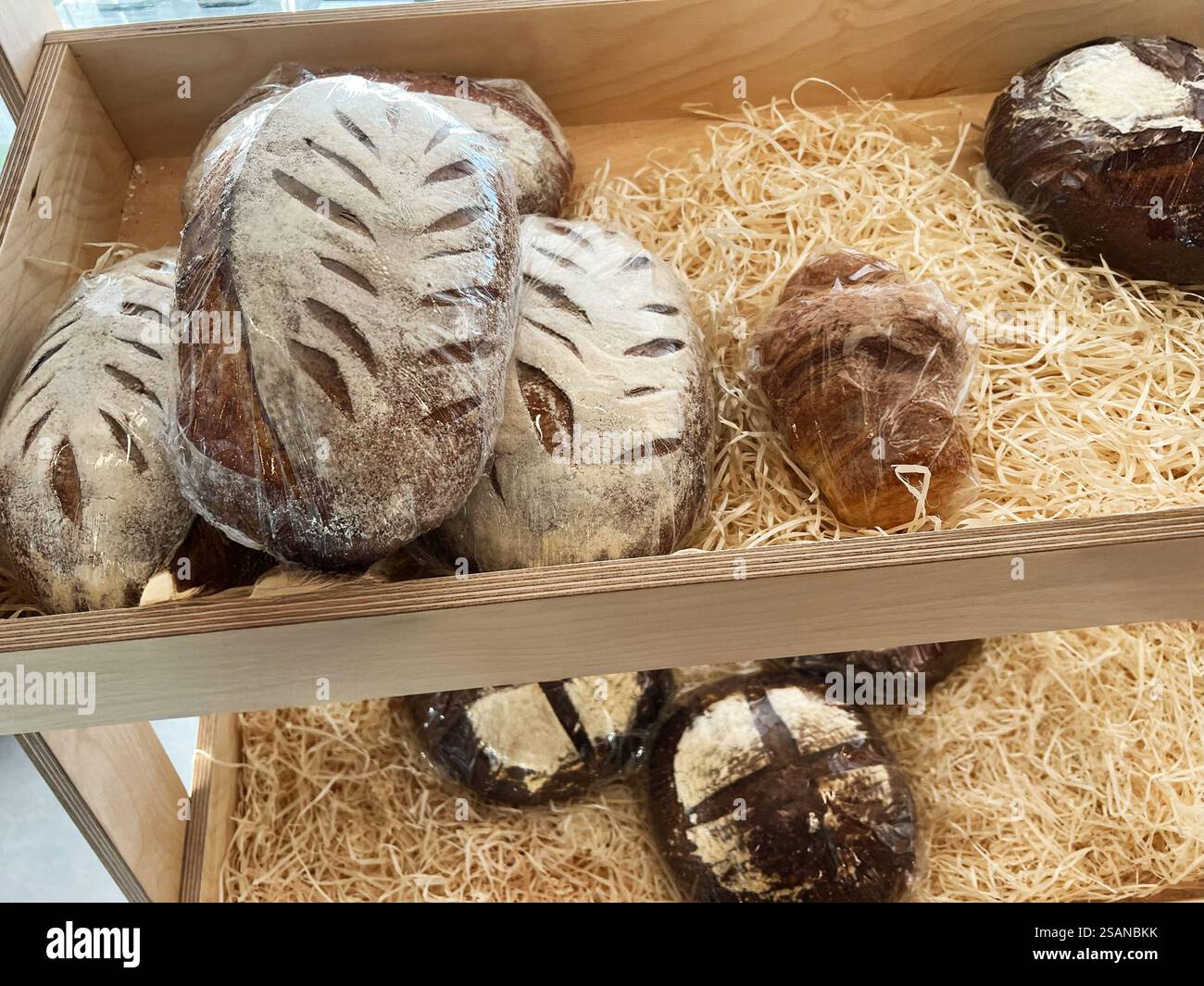 A selection of freshly crafted artisan breads, including rustic loaves ...