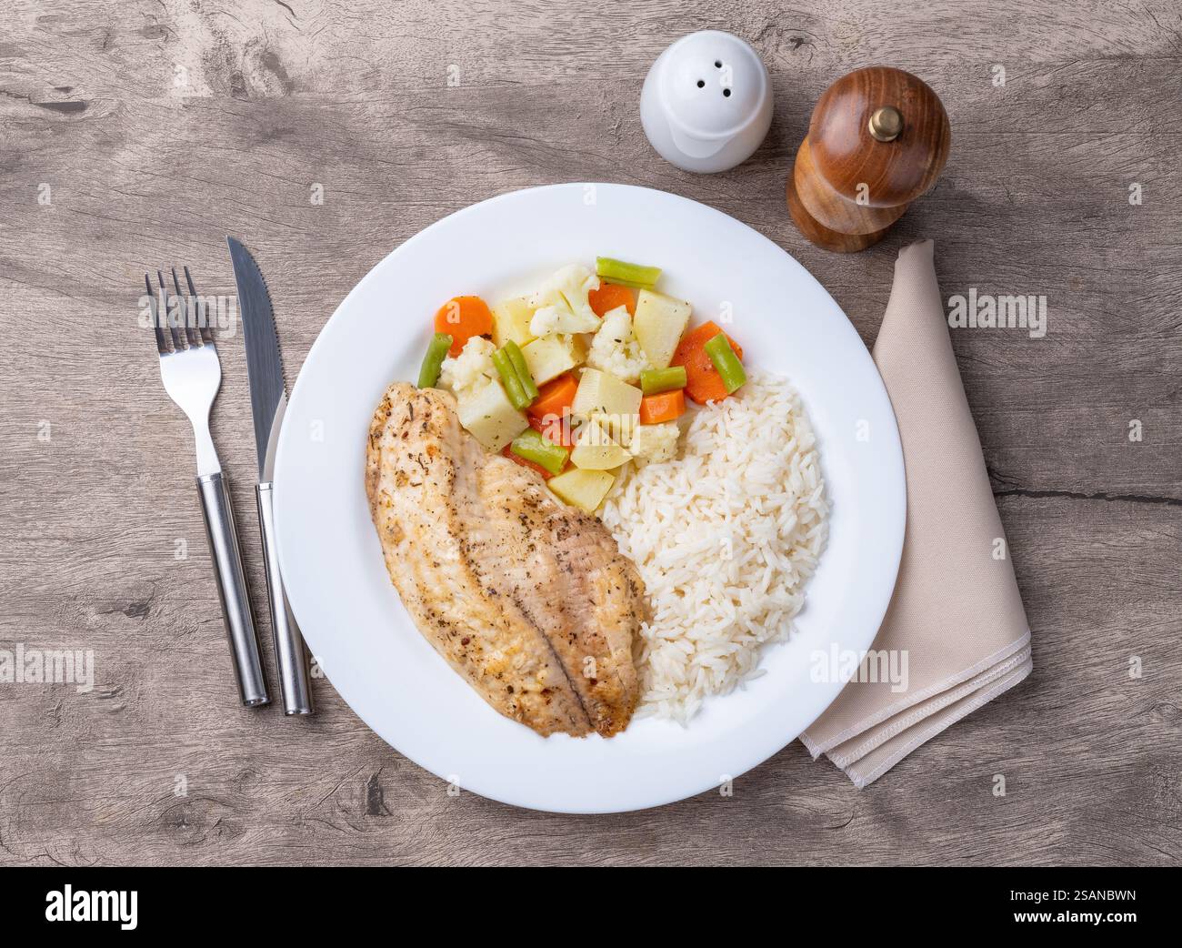 Grilled tilapia or saint peter with rice and vegetables Stock Photo - Alamy