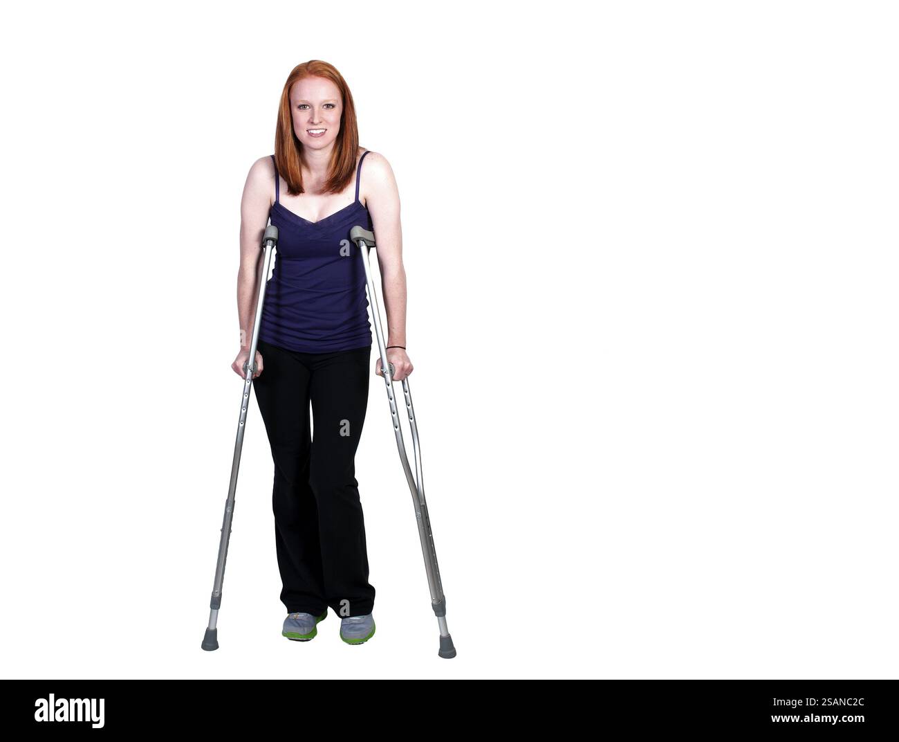 A beautiful woman using a set of medical crutches to help her walk ...