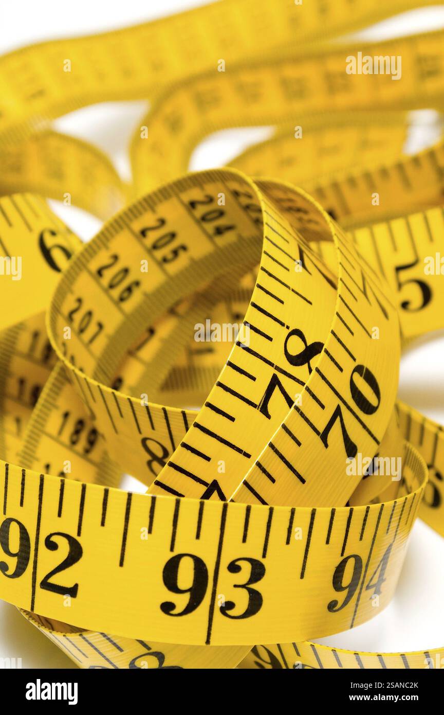 A tailor's measuring tape coiled up randomly Stock Photo - Alamy