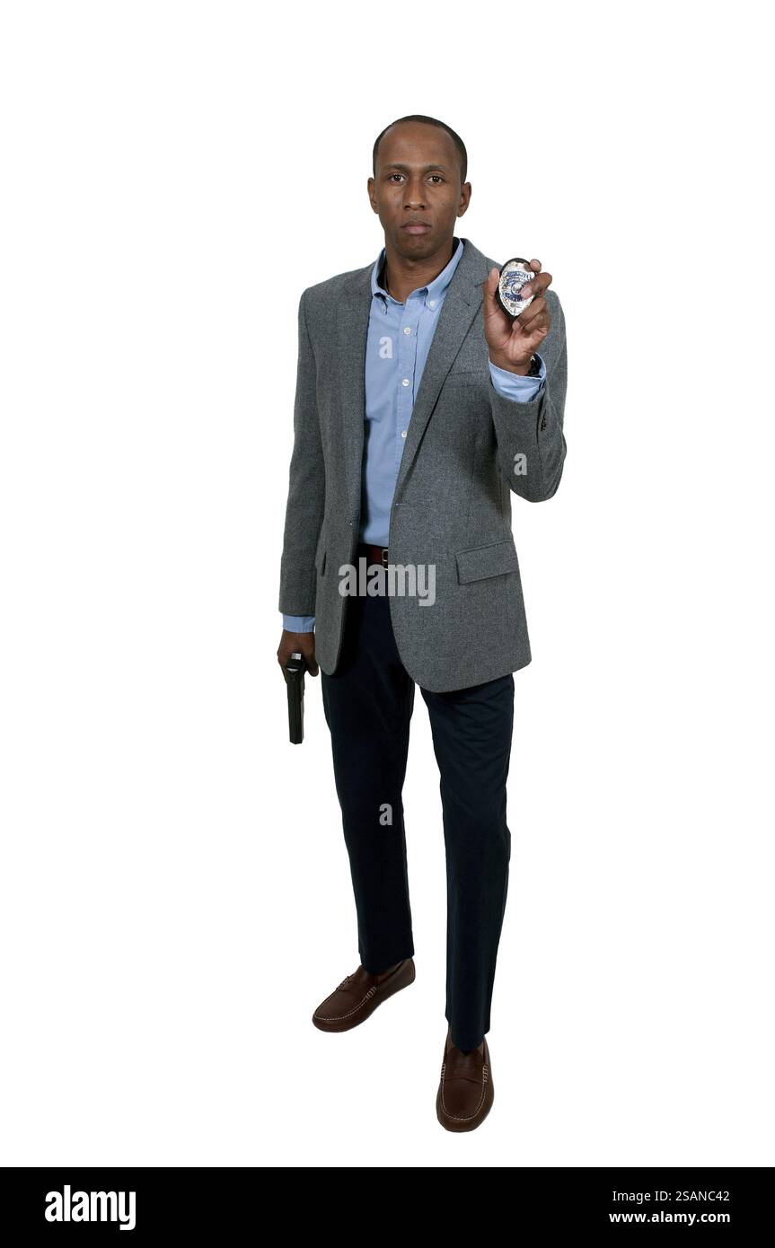 A black African American police detective man on the job with a gun ...