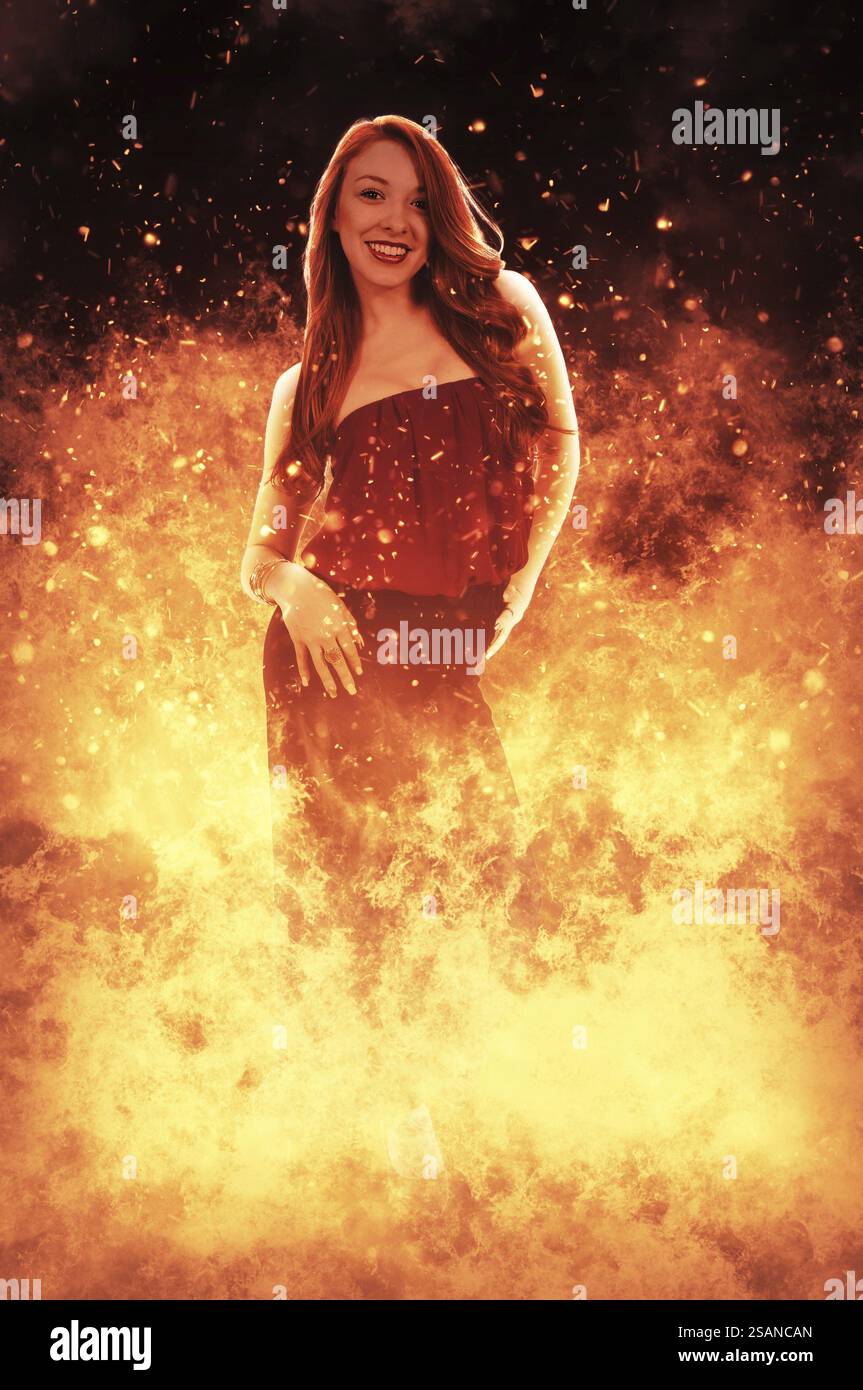 Beautiful woman standing in the midst of a fire Stock Photo - Alamy