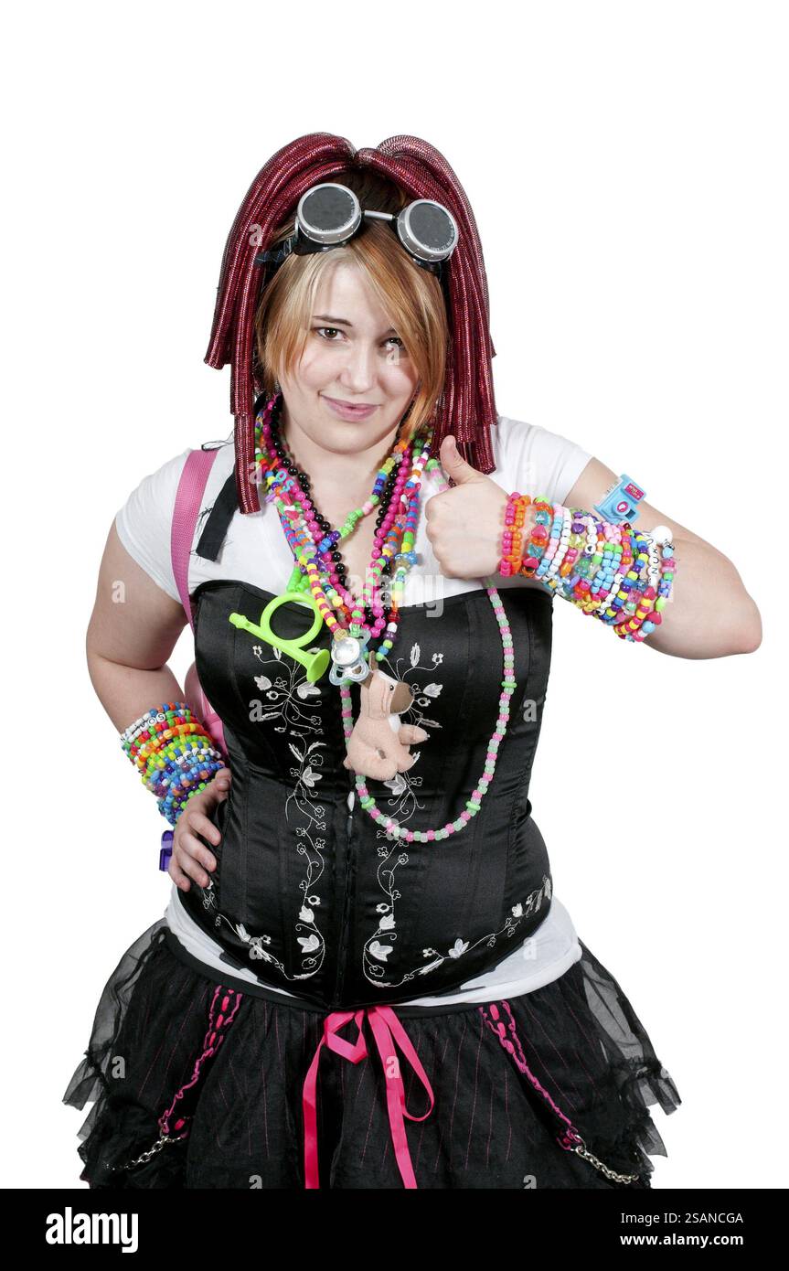 A young woman dressed to go to a rave party dance giving a thumbs up ...