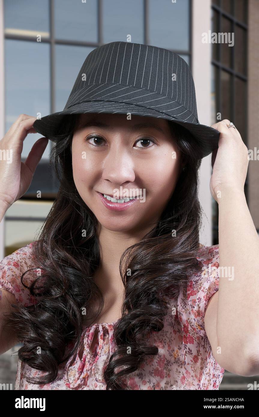 Beautiful asian woman in a fedora hat Stock Photo - Alamy