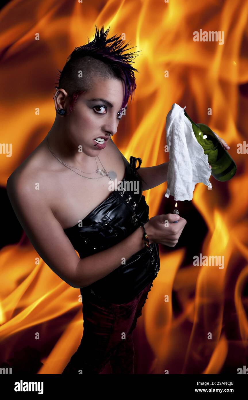 Beautiful rebellious punk rock woman throwing a molotov cocktail Stock ...