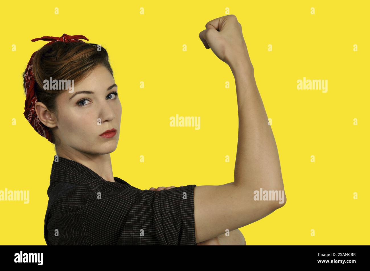 Beautiful woman dressed as the iconic Rosie the Riveter Stock Photo - Alamy