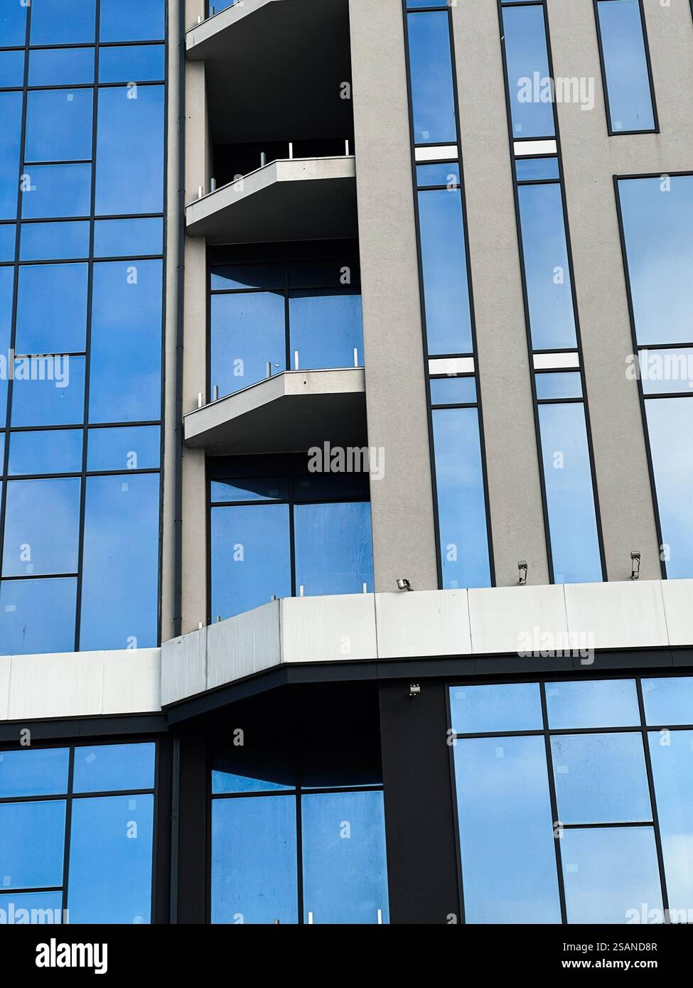 Contemporary design of a building showcasing glass panels reflecting ...