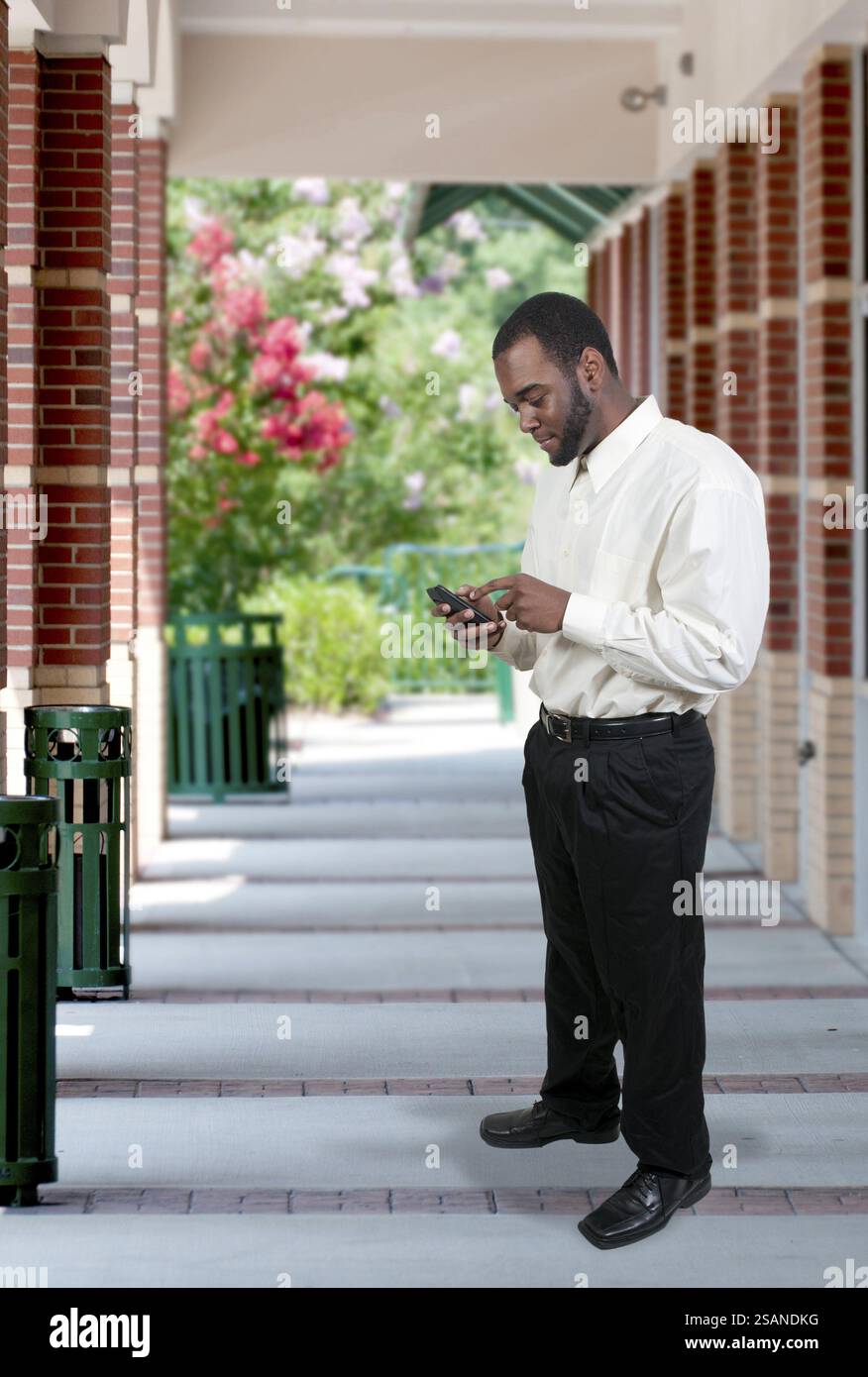 Black African American business man using a cell phone for texting ...