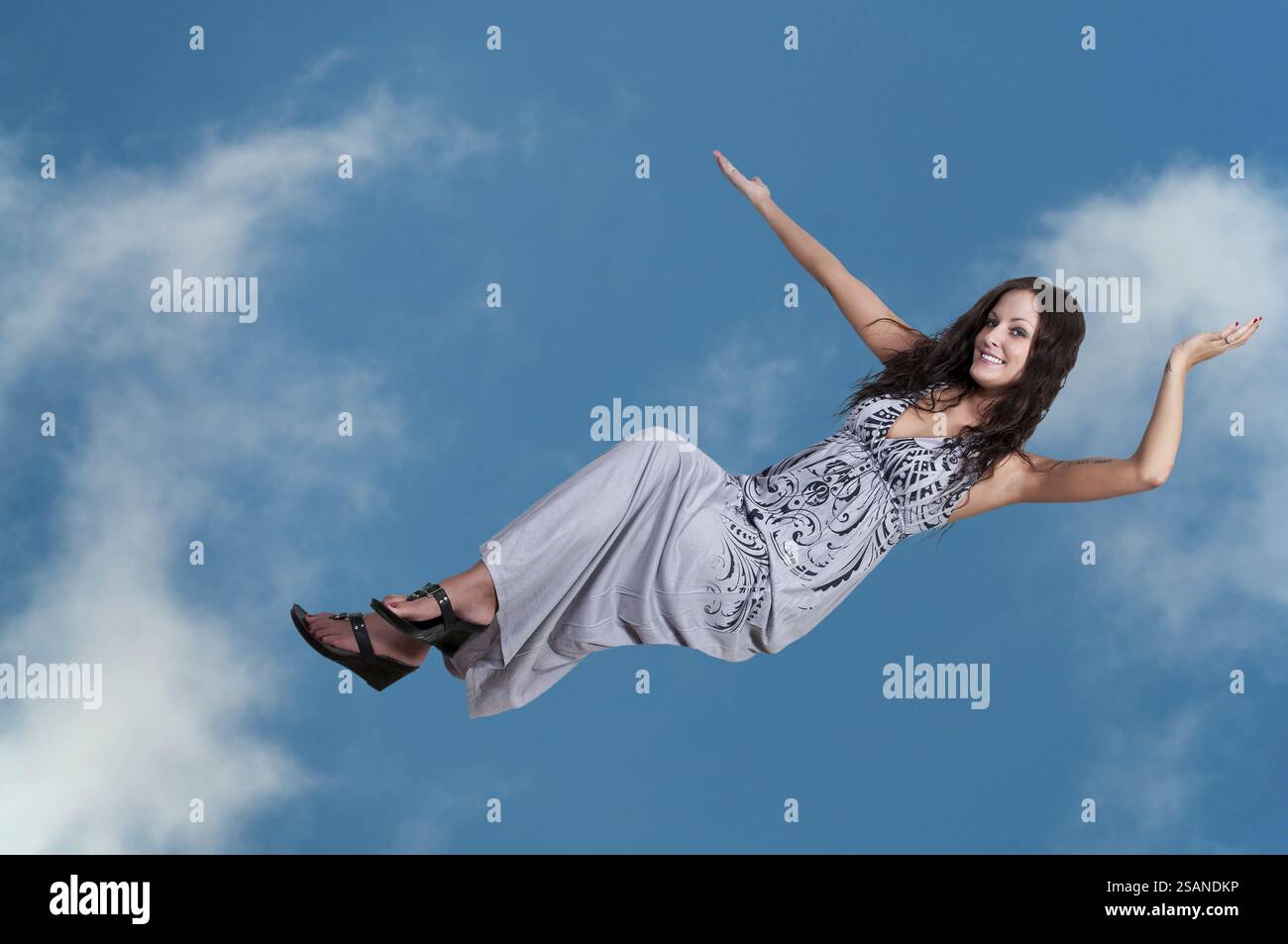 A beautiful young woman falling through the sky Stock Photo - Alamy