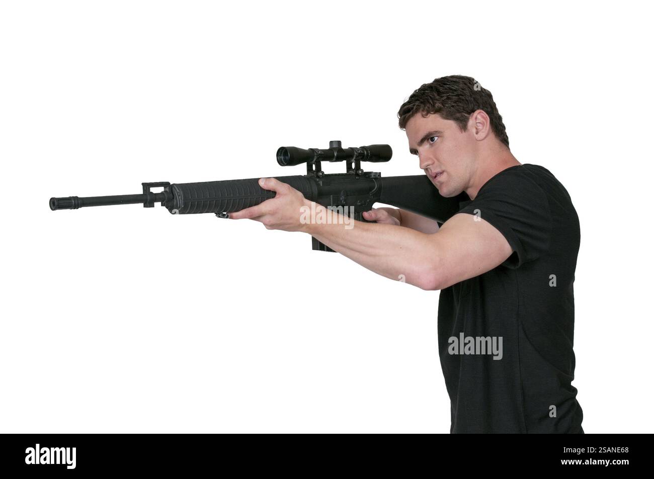 Handsome man holding an automatic assault rifle Stock Photo - Alamy