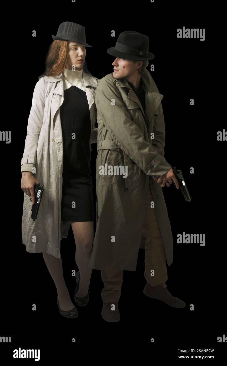 Man and woman secret agent spies with guns Stock Photo - Alamy