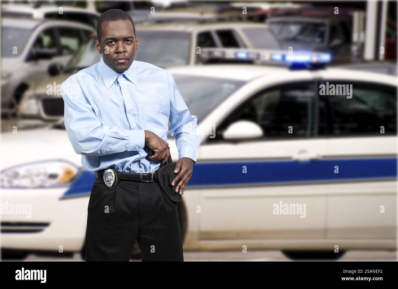 A black African American police detective man on the job with a gun ...