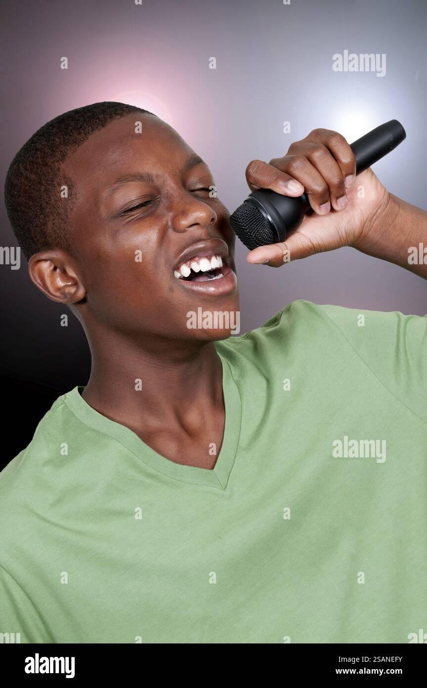 Young teenage black African American boy singer performing at a concert ...