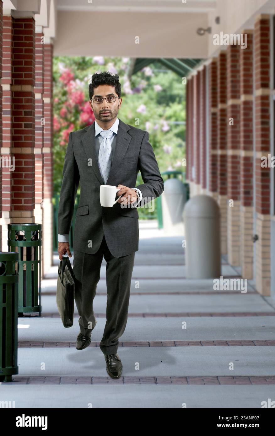 Handsome young man carrying his important papers in a briefcase and ...
