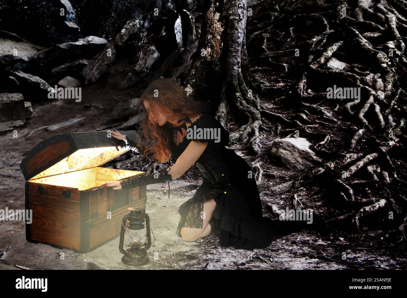 Beautiful young woman pirate opening a treasure chest Stock Photo - Alamy