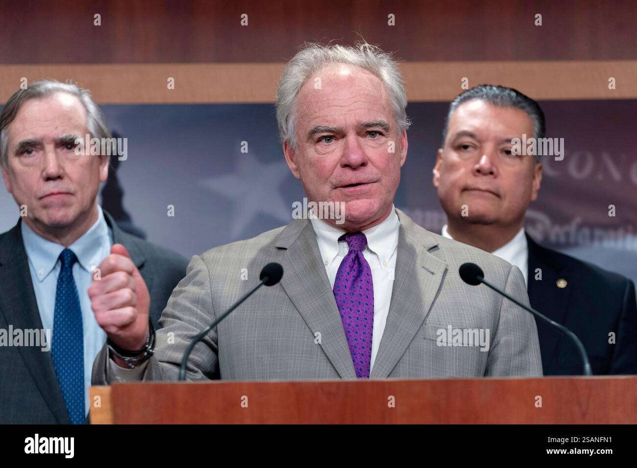 Sen. Tim Kaine, D-Va., flanked by Sen. Jeff Merkley, D-Ore., left, and ...