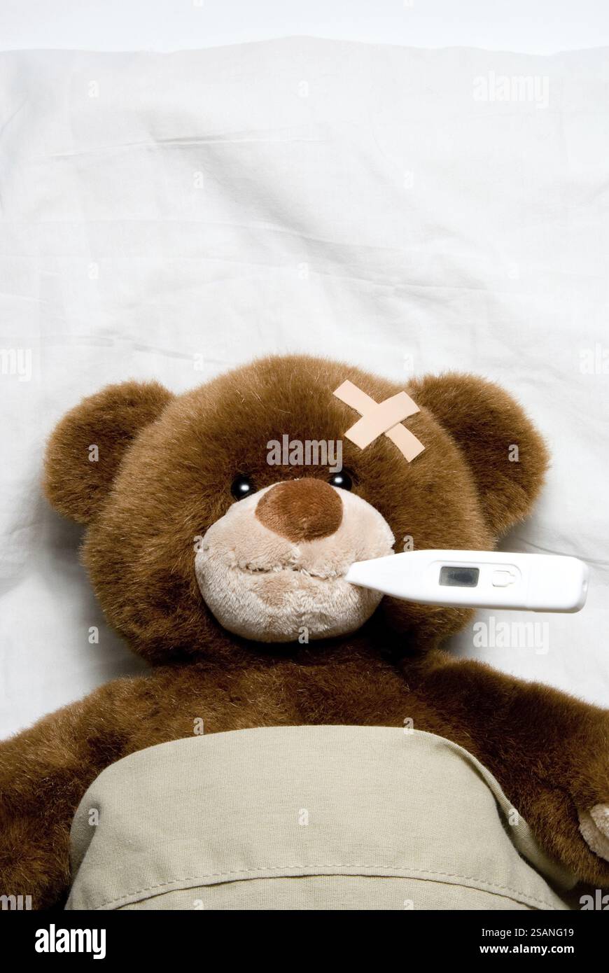 A very Sick Teddy Bear laying in a bed Stock Photo - Alamy