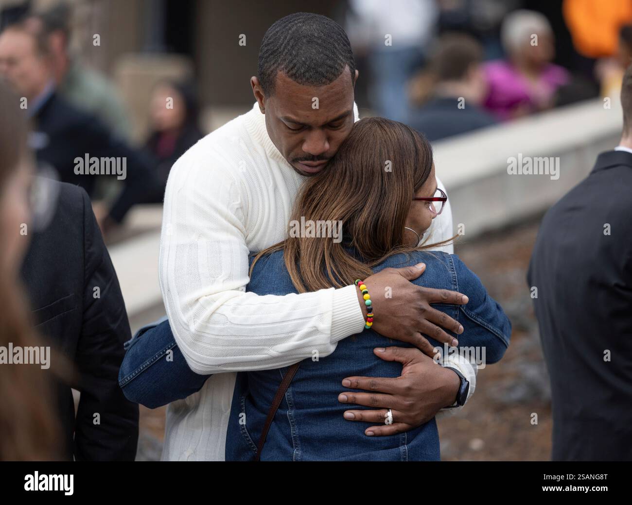 Wichita city council member Brandon Johnson hugs pastor Michelle Vann ...