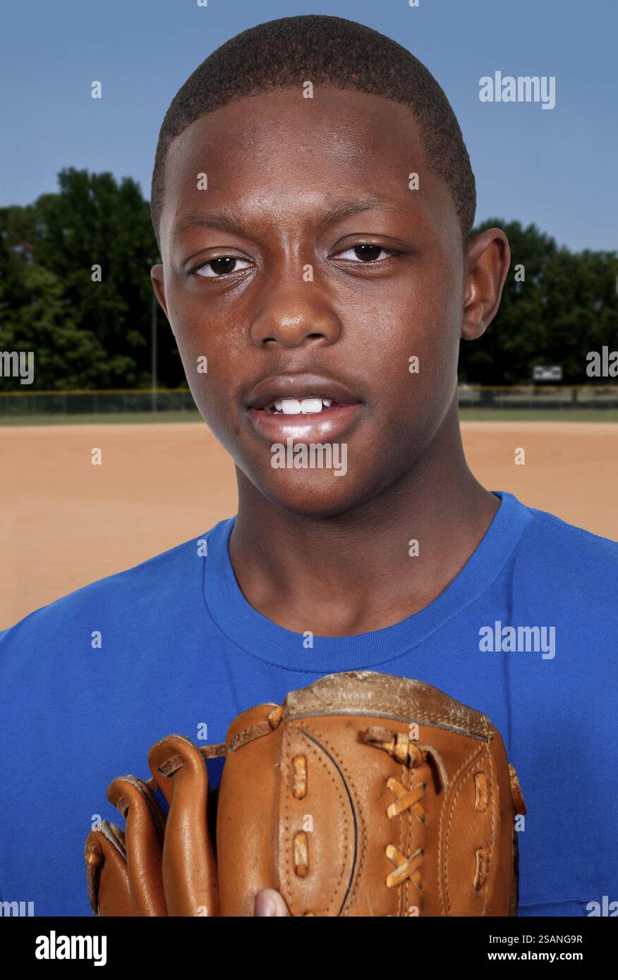 A black African American teenage man baseball pitcher getting ready to ...