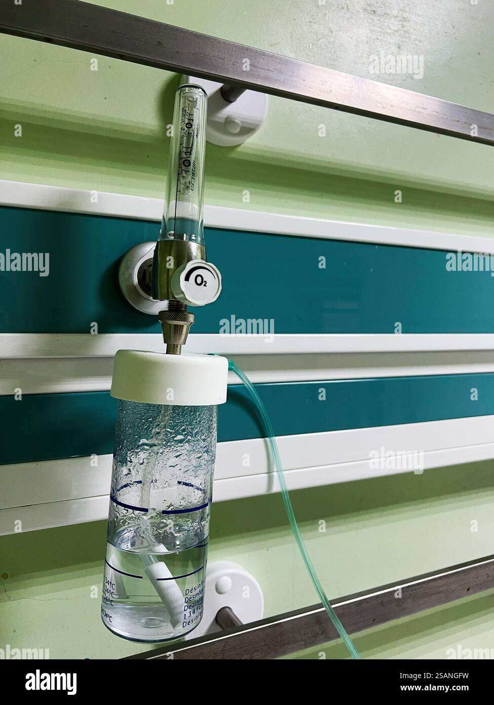 Oxygen flow regulator and humidifying bubbler bottle mounted on a ...