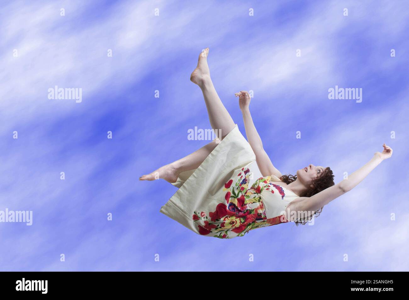 A beautiful young woman falling through the sky Stock Photo - Alamy