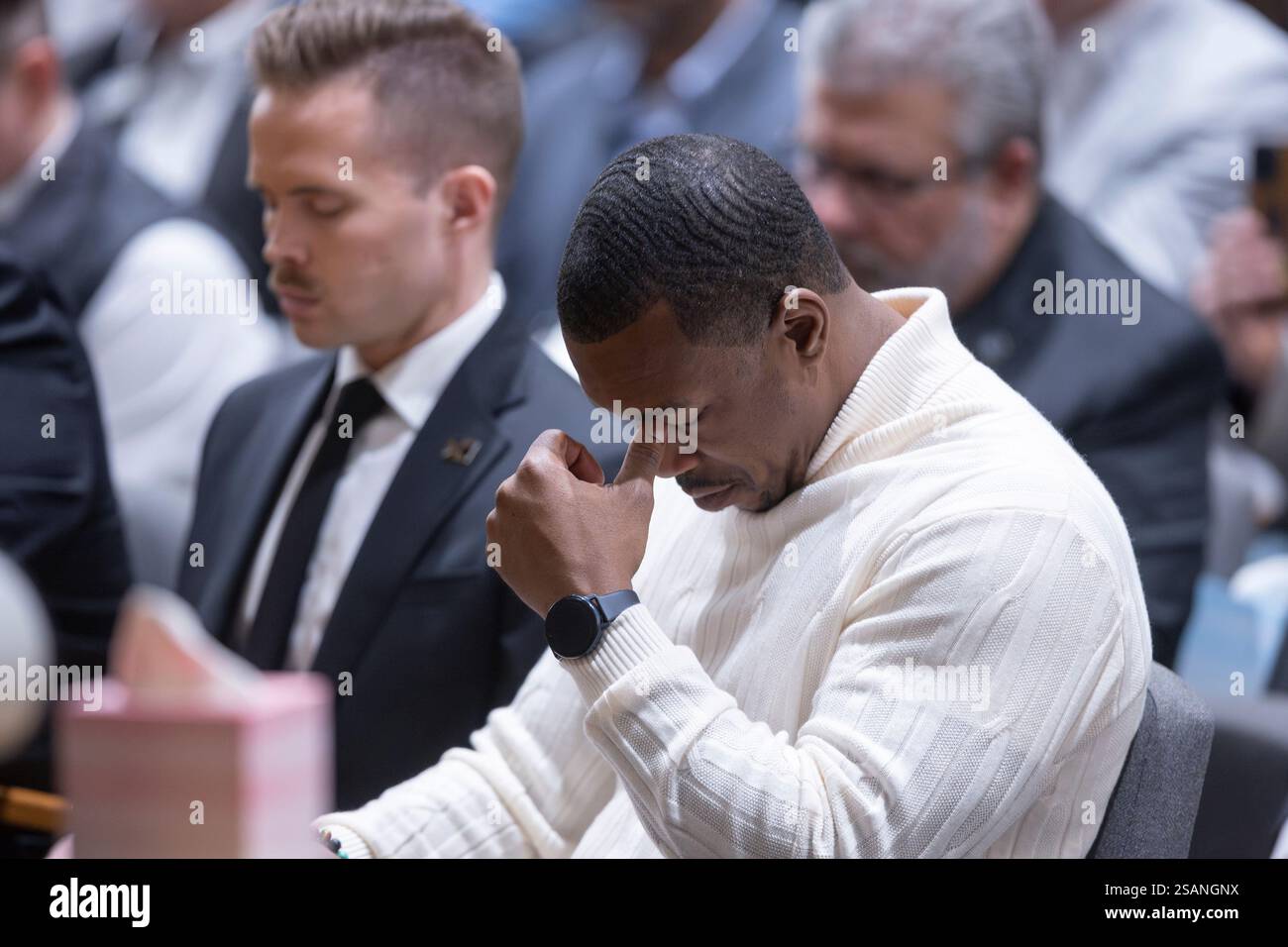 Wichita, Kan., city council member Brandon Johnson grieves during a ...