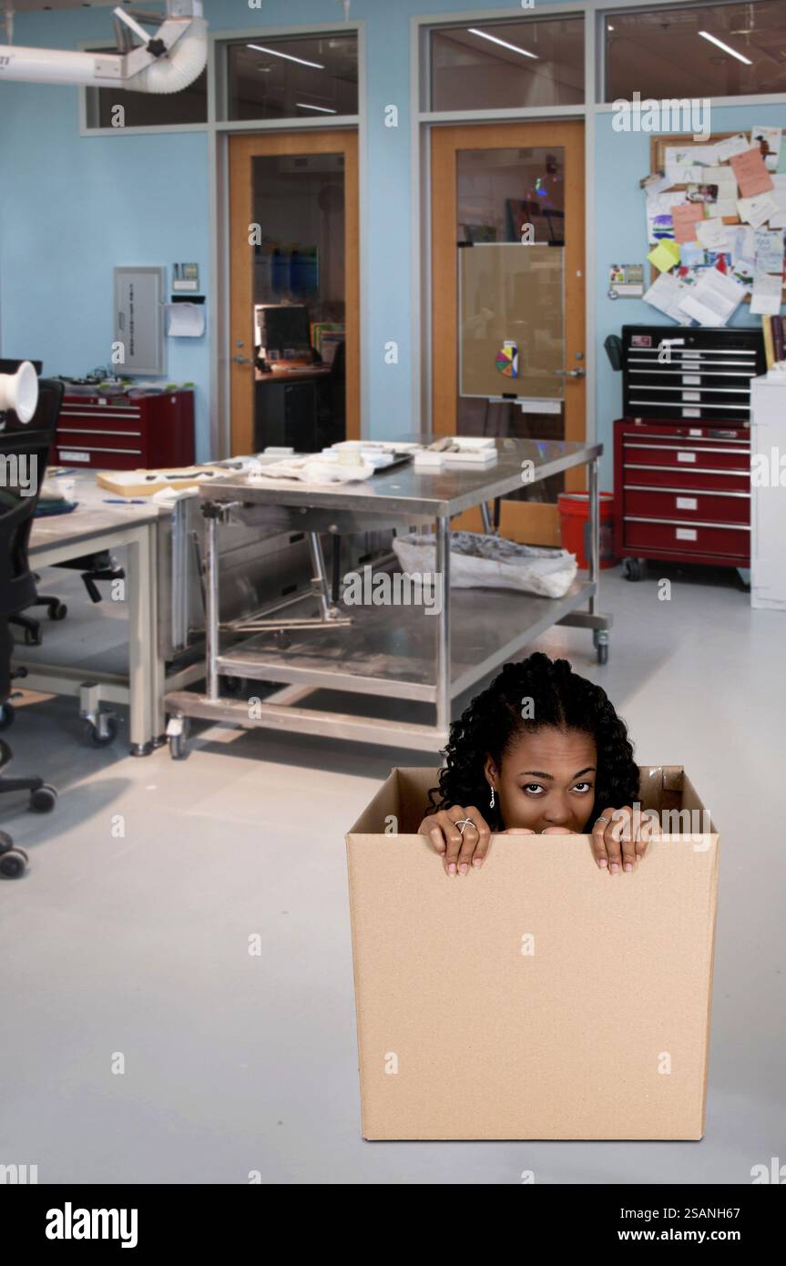 Beautiful black woman thinking while standing beside a box Stock Photo ...