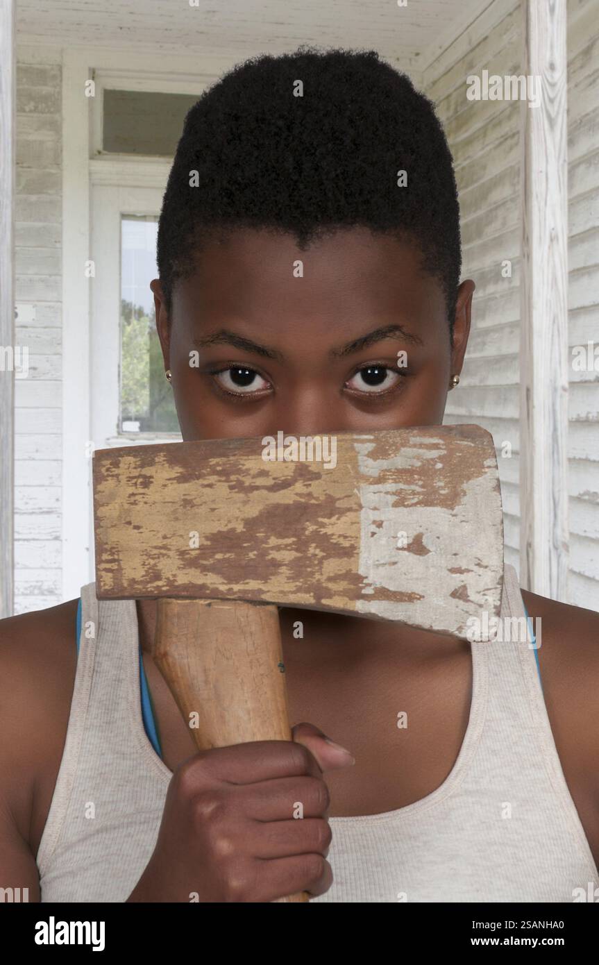 Beautiful possessed woman in a trance holding an axe Stock Photo - Alamy
