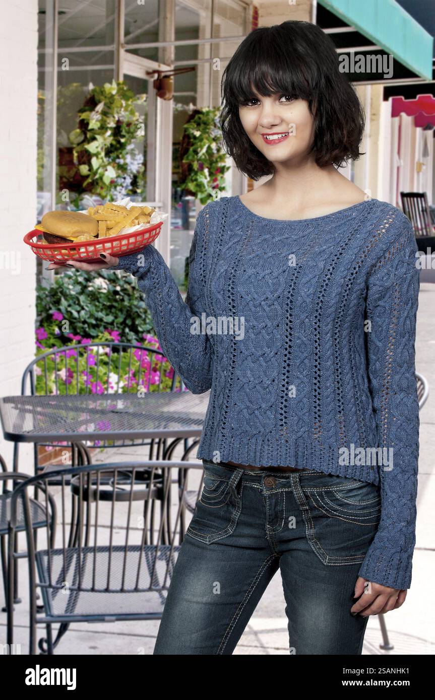 Beautiful woman waitress serving hamburger and fries Stock Photo - Alamy