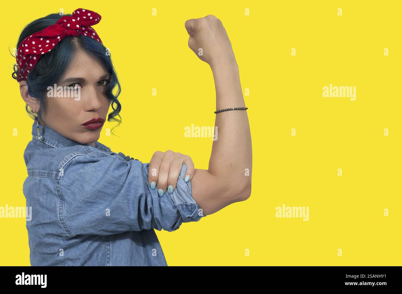 Beautiful woman dressed as the iconic Rosie the Riveter Stock Photo - Alamy