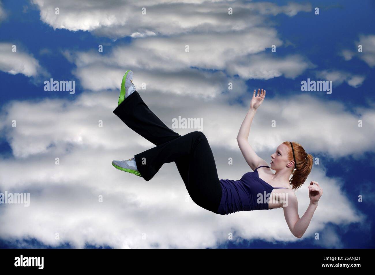 A beautiful young woman falling through the sky Stock Photo - Alamy