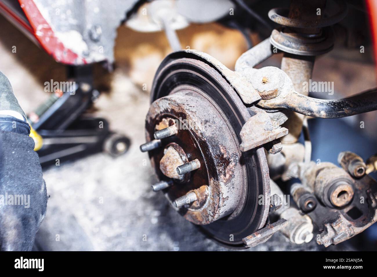 Rusted car brake system shown in detail as part of a maintenance ...