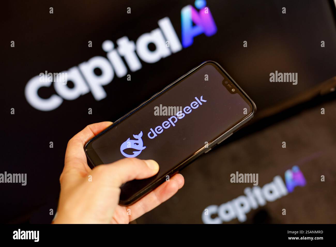 In this photo illustration the Capital AI logo is shown on two computer ...