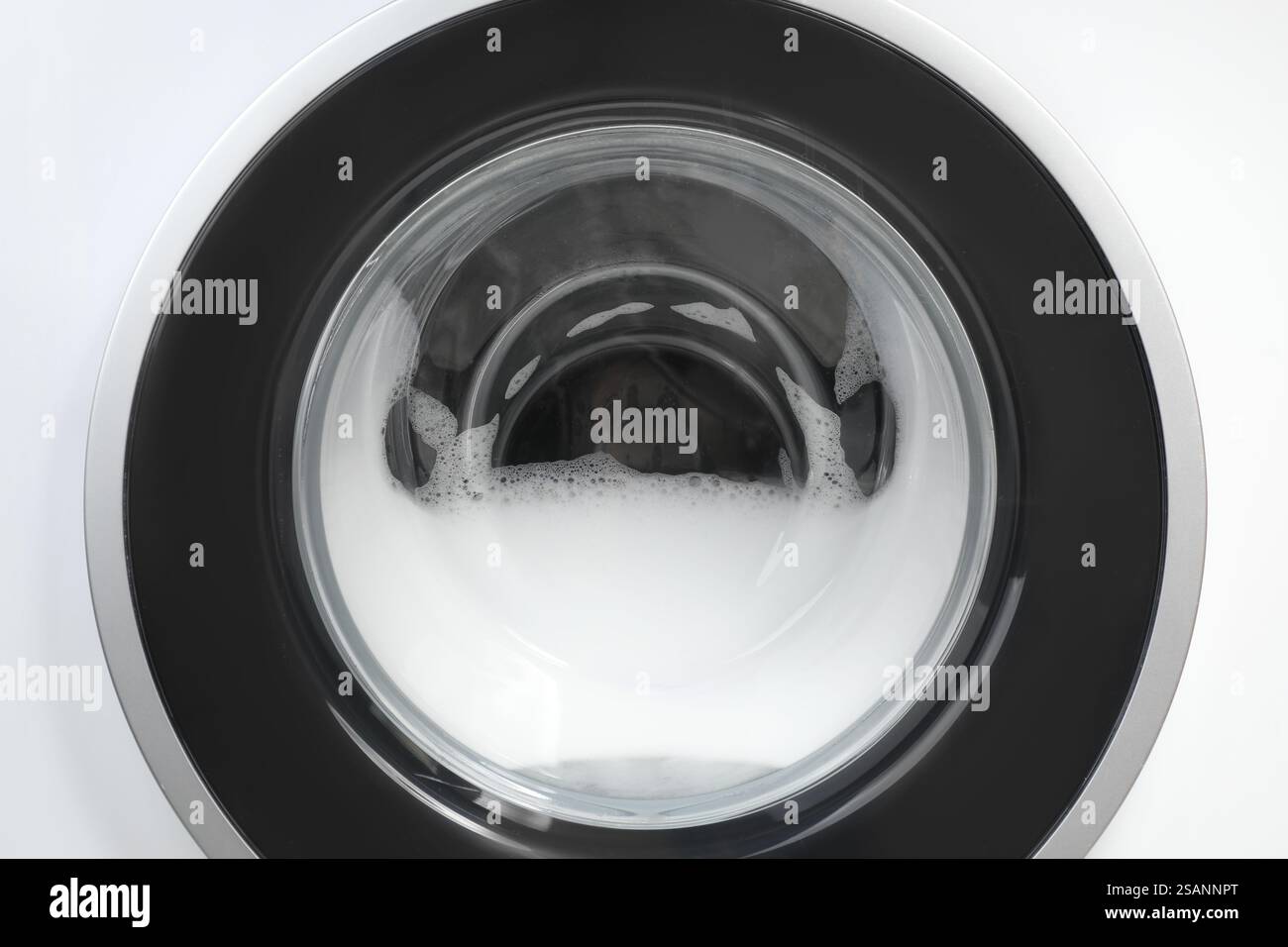 Washing machine with suds as background, closeup Stock Photo - Alamy