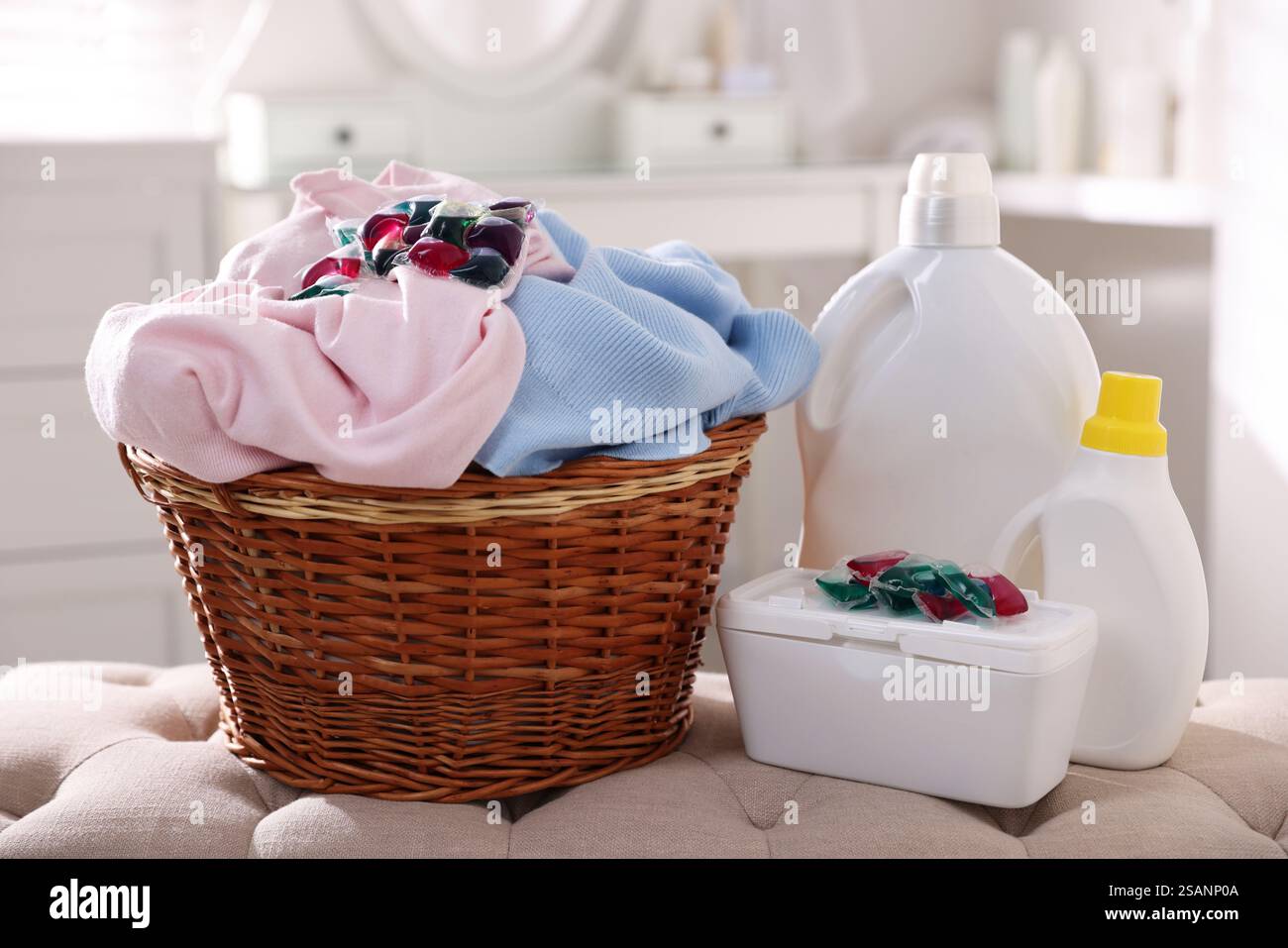 Laundry capsules, detergents and basket with clothes in bathroom Stock ...