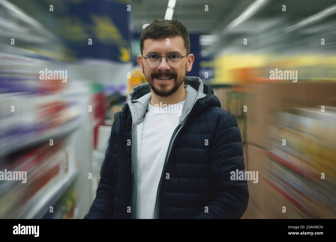 Happy guy in a hypermarket Stock Photo - Alamy