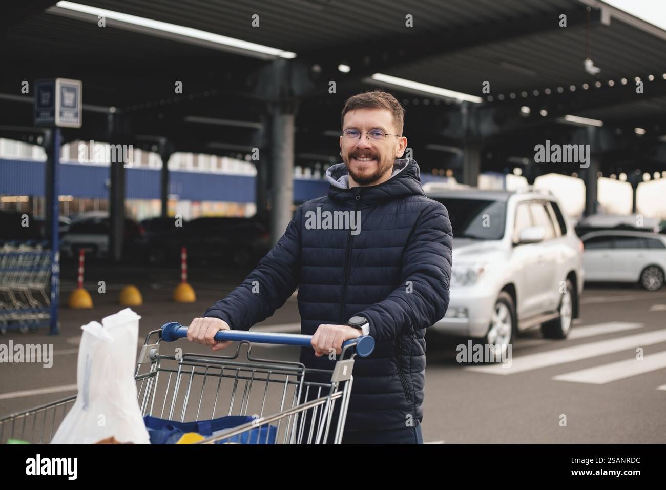 Happy guy in a hypermarket Stock Photo - Alamy