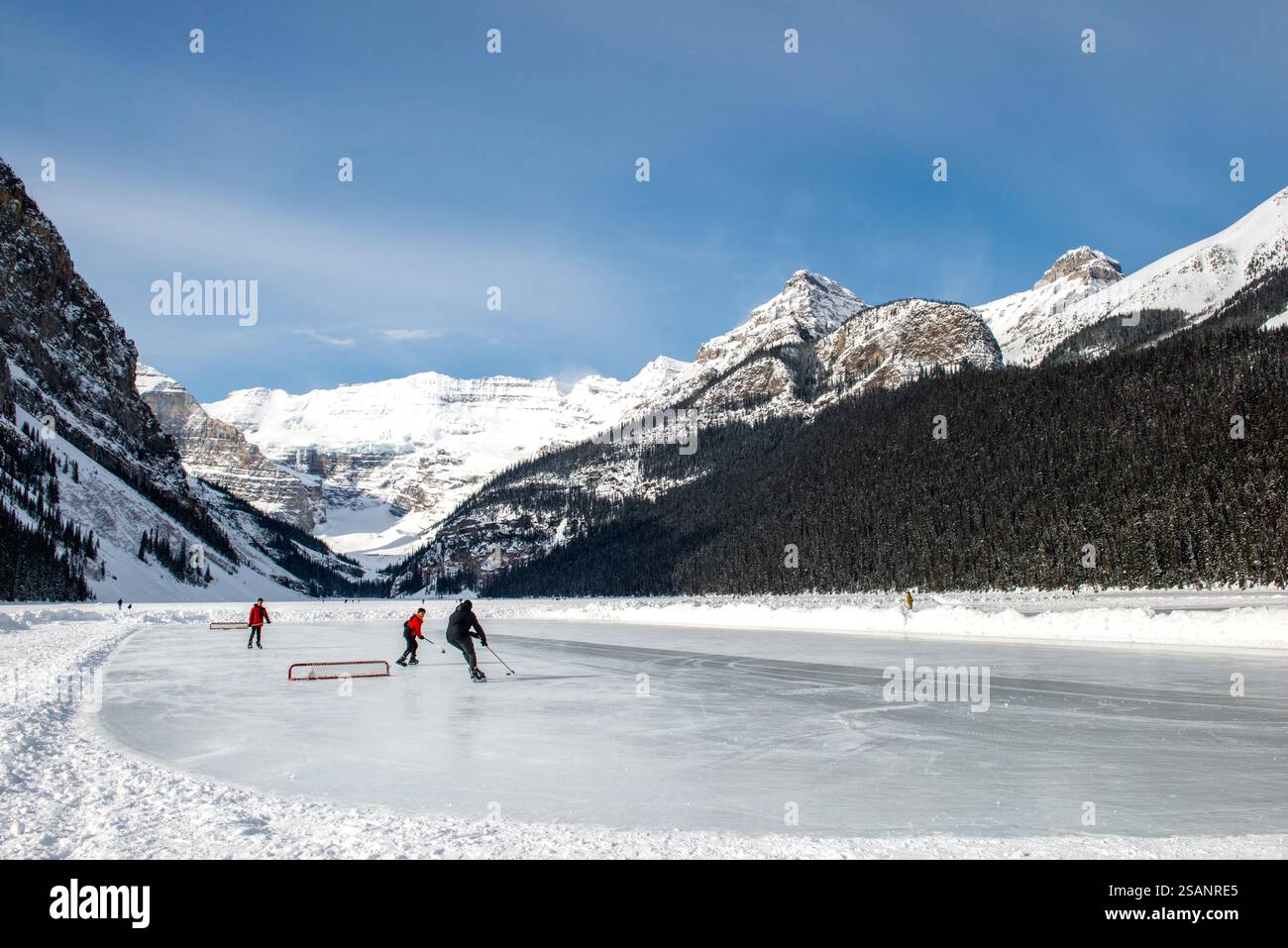 People playing ice hockey on iconic frozen Lake Louise in Banff ...